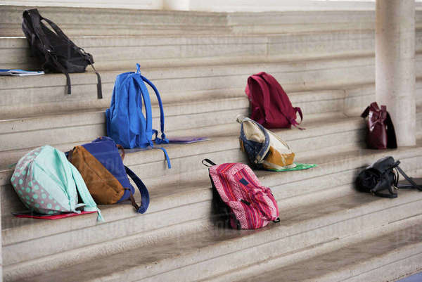 Backpacks left on stairs - Royalty-free Stock Photo | Dissolve