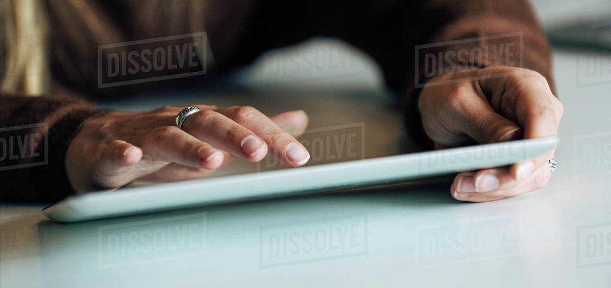 Businesswoman using digital tablet - Stock Photo - Dissolve