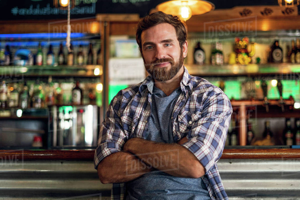 Portrait of man leaning against bar counter - Royalty-free Stock Photo ...