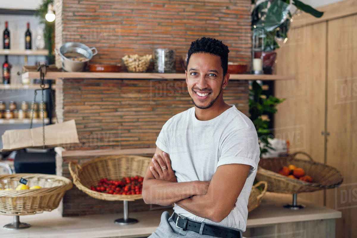 Portrait of man sitting in shop - Stock Photo - Dissolve