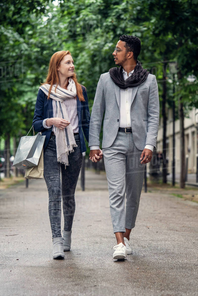 Couple walking on street - Royalty-free Stock Photo | Dissolve