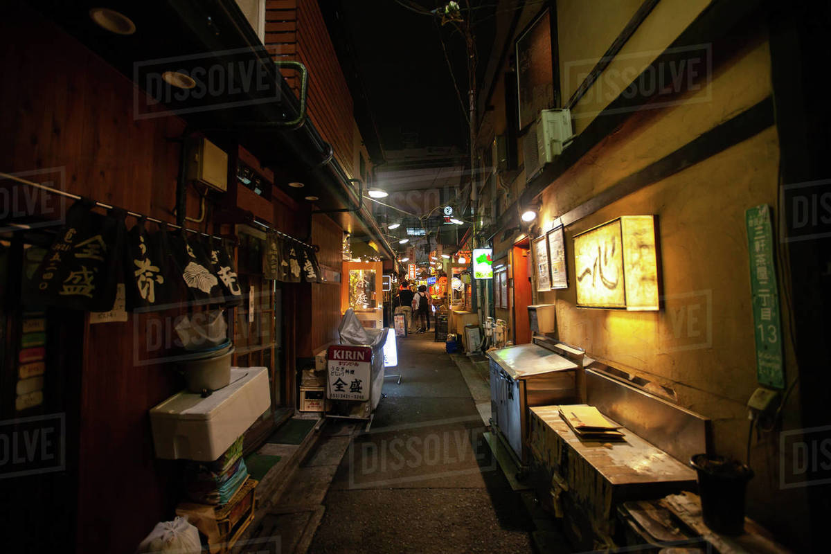 Illuminated signs of restaurant and shops at night - Stock Photo - Dissolve