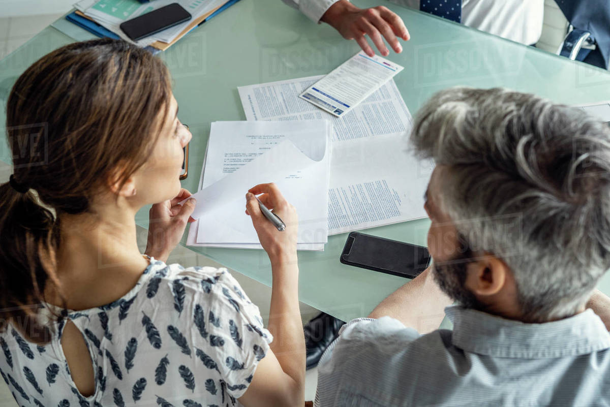 Couple signing document in office - Royalty-free Stock Photo | Dissolve