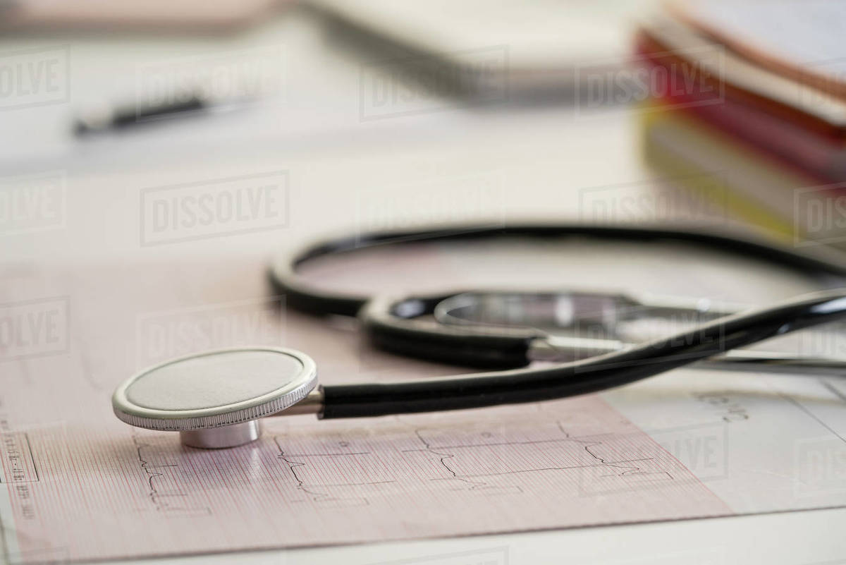 Stethoscope on medical report - Stock Photo - Dissolve