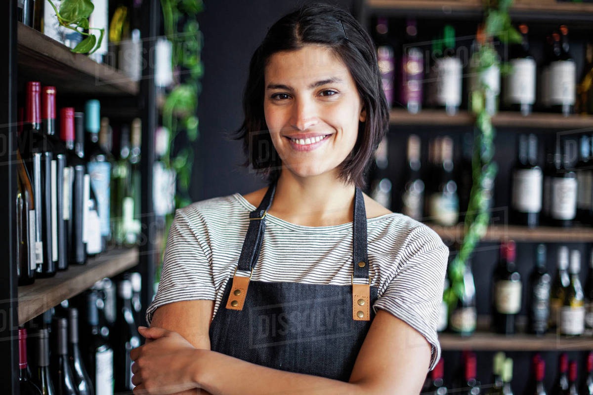 Liquor store owner looking at the camera with arms crossed - Royalty ...