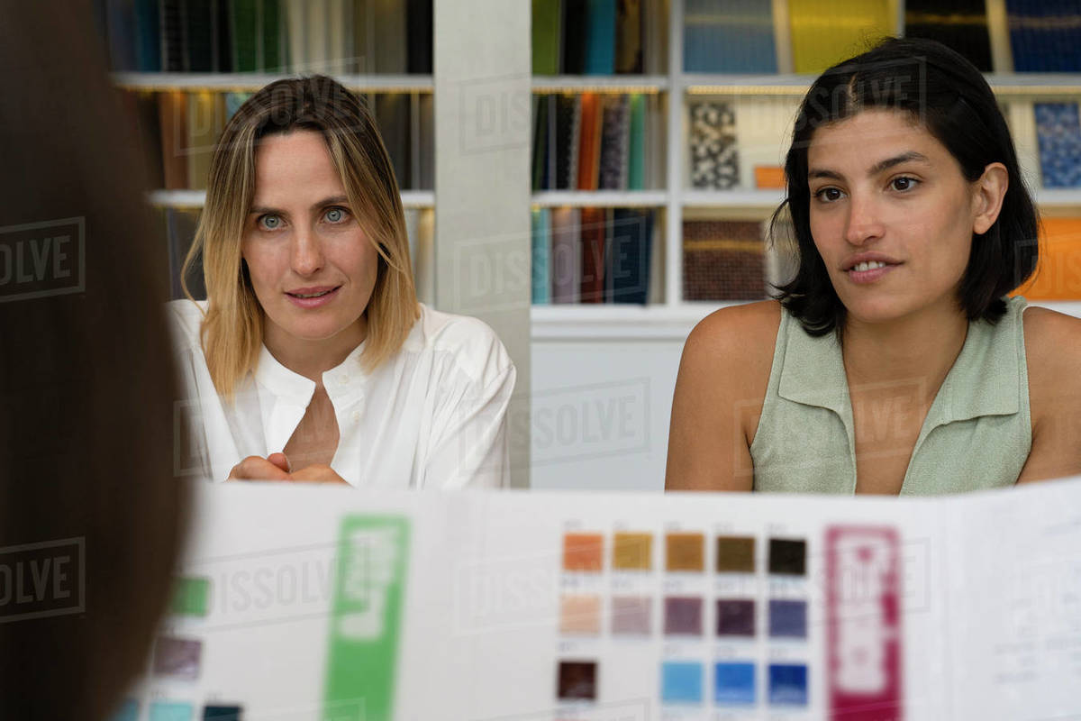 Medium shot of two diverse female interior designers interviewing a ...