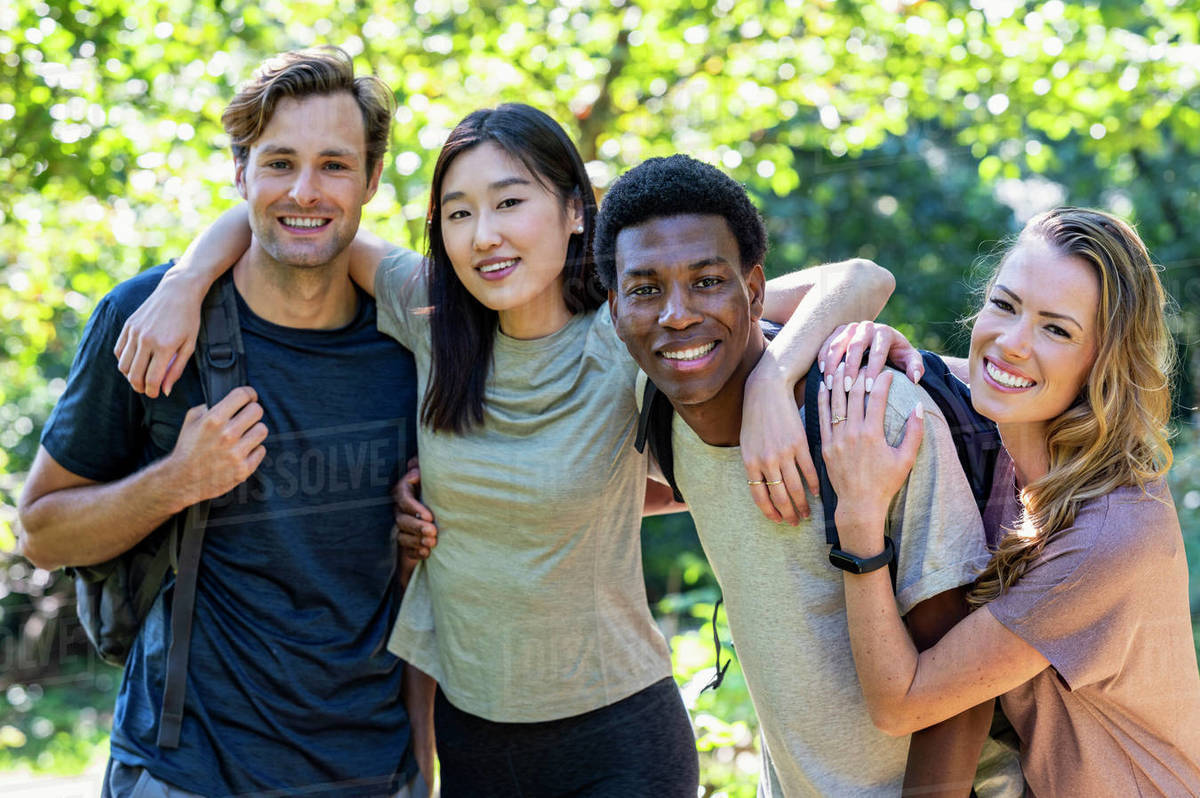 Portrait of small group of friends looking at the camera during hiking ...