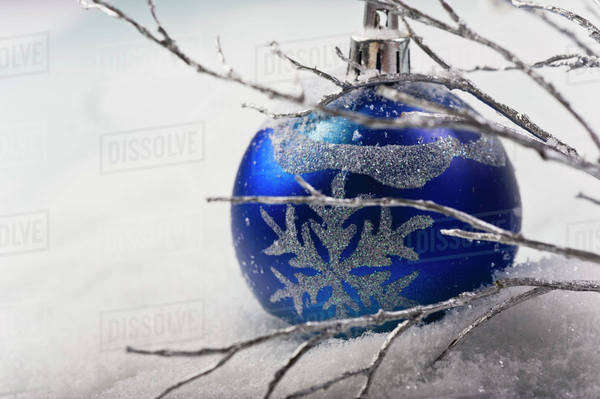 Blue bauble in snow - Royalty-free Stock Photo | Dissolve