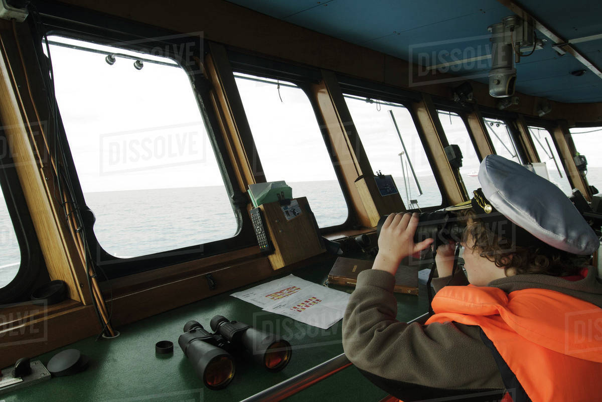 Boy playing captain, cockpit - Stock Photo - Dissolve