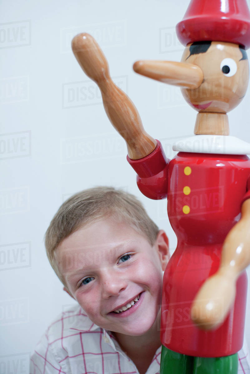 Boy and toy figurine - Royalty-free Stock Photo | Dissolve