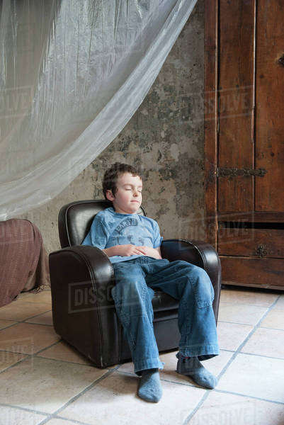 Boy napping in armchair - Royalty-free Stock Photo | Dissolve