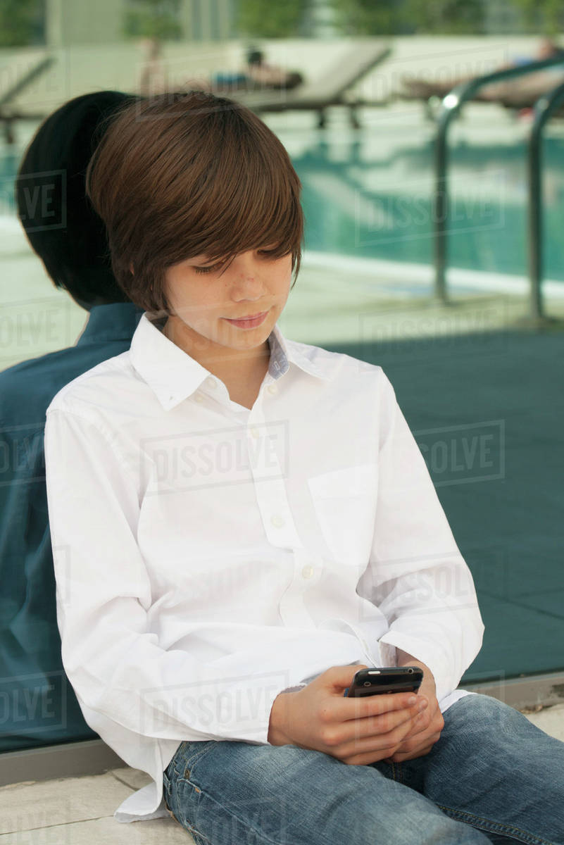 Teenage boy using cell phone - Royalty-free Stock Photo | Dissolve