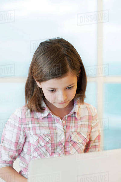 Girl using laptop computer - Royalty-free Stock Photo | Dissolve