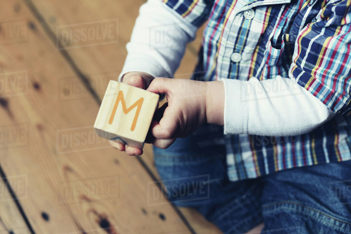 Baby playing with abc blocks, cropped - Royalty-free Stock Photo | Dissolve
