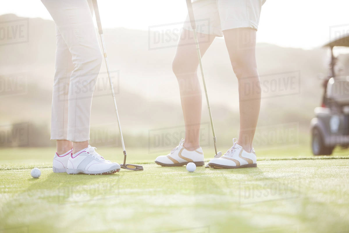 Women standing on golf course - Royalty-free Stock Photo | Dissolve