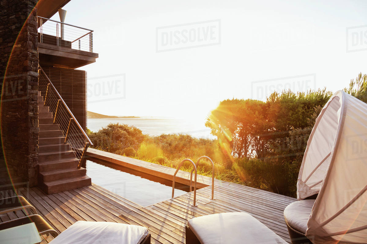 Luxury patio overlooking ocean at sunset - Royalty-free Stock Photo ...