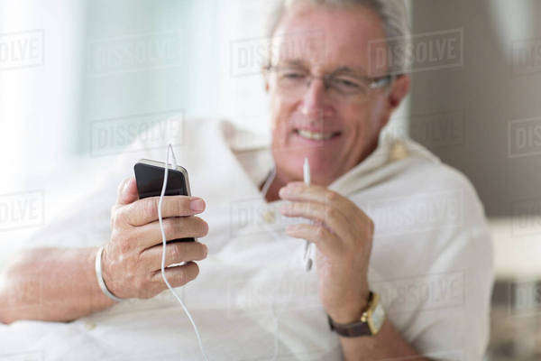Older man using cell phone - Stock Photo - Dissolve