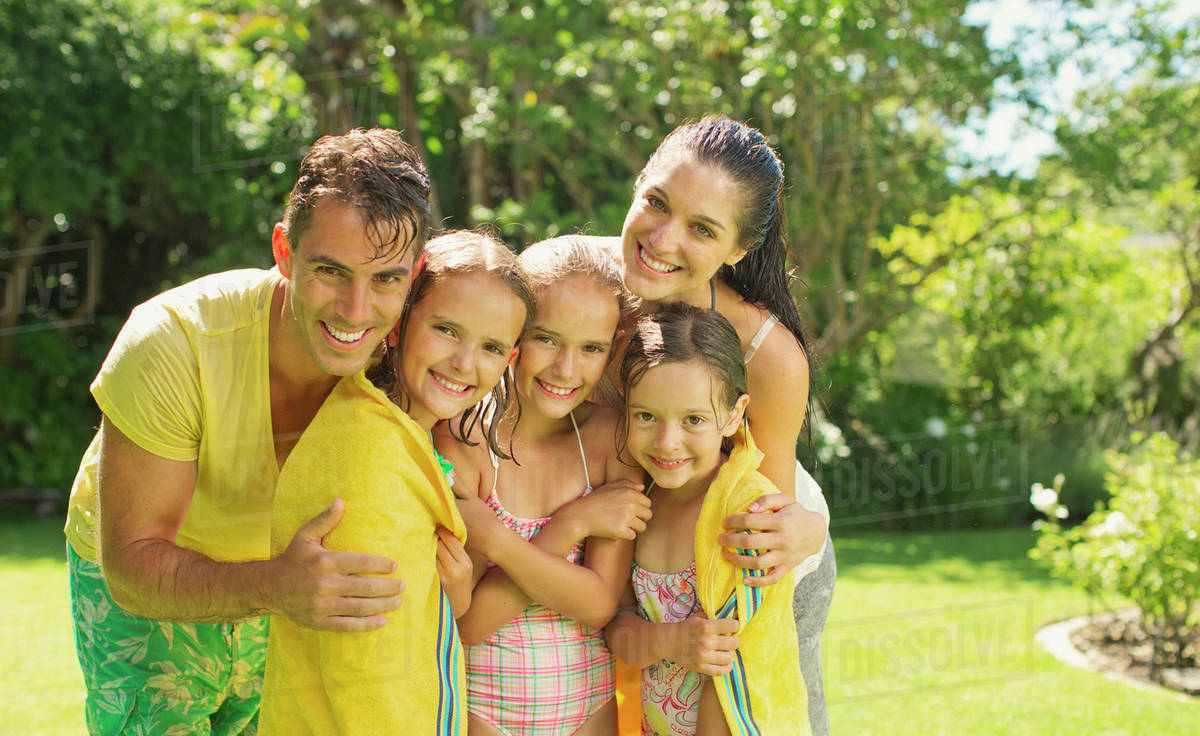 Family relaxing together in backyard - Royalty-free Stock Photo | Dissolve