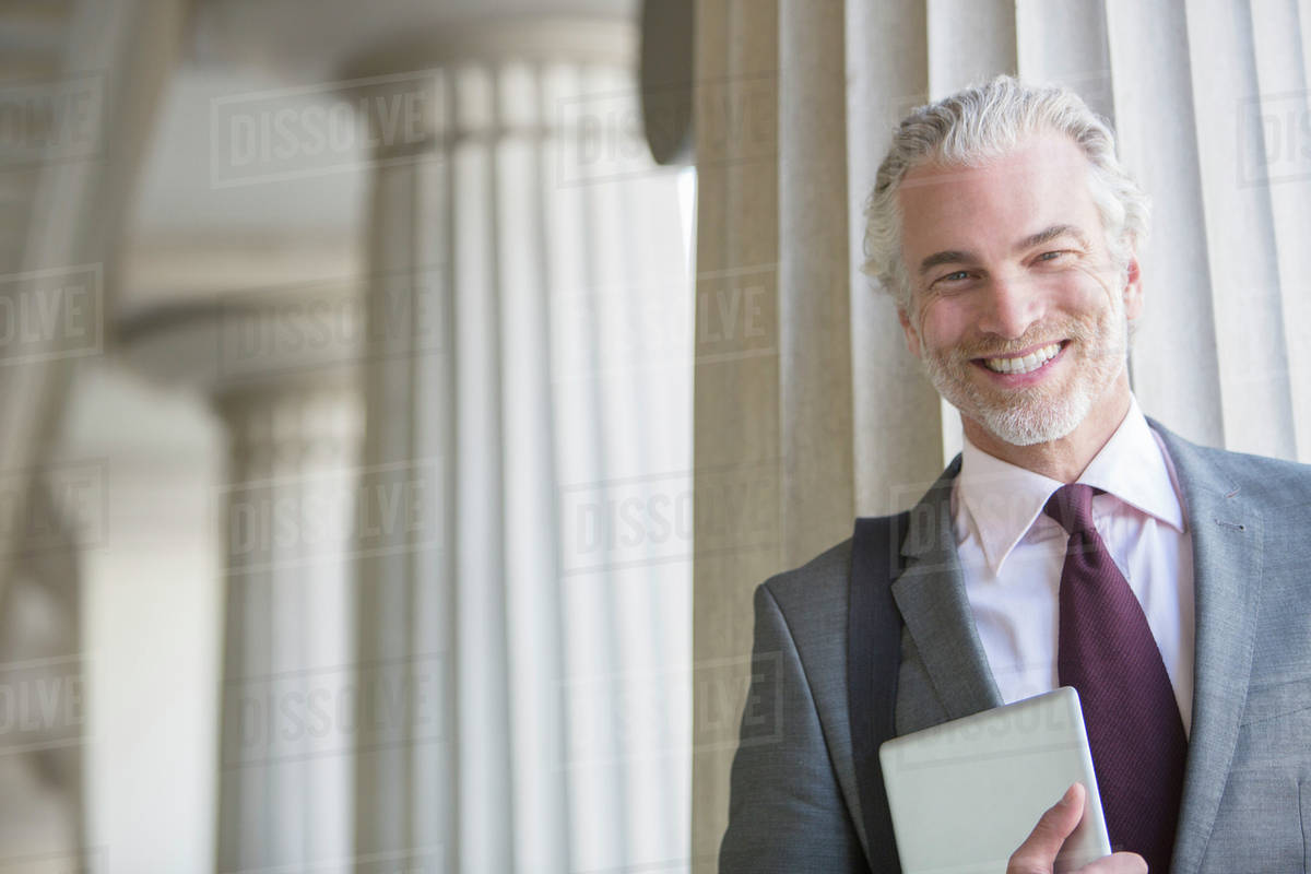 Businessman smiling outdoors - Royalty-free Stock Photo | Dissolve