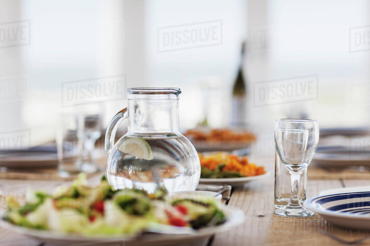Food and water on set table - Stock Photo - Dissolve