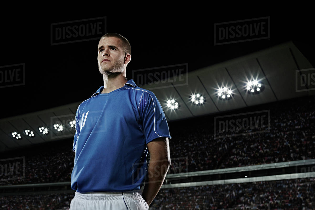 Soccer player standing in stadium - Royalty-free Stock Photo | Dissolve
