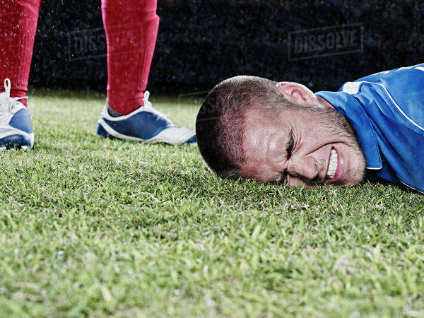 Soccer player falling on field - Royalty-free Stock Photo | Dissolve