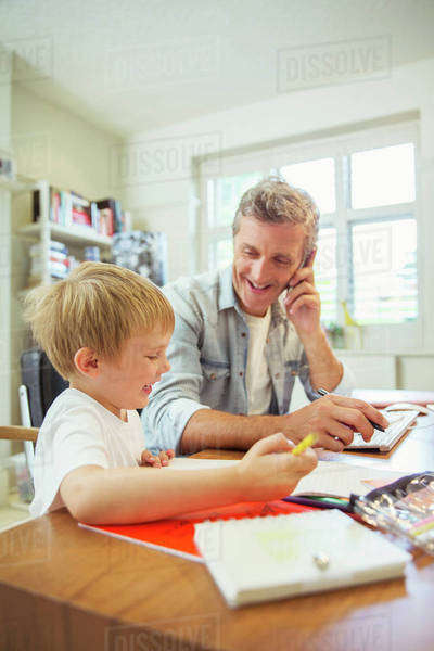 Father and son working in home office - Royalty-free Stock Photo | Dissolve