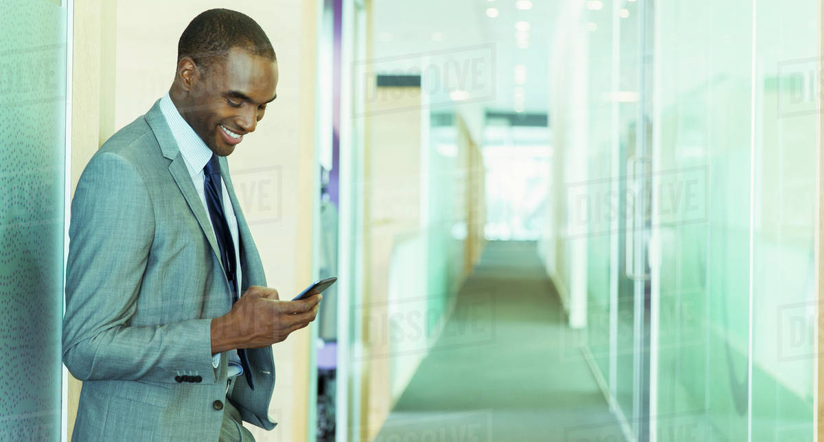 Businessman using cell phone in office - Royalty-free Stock Photo ...