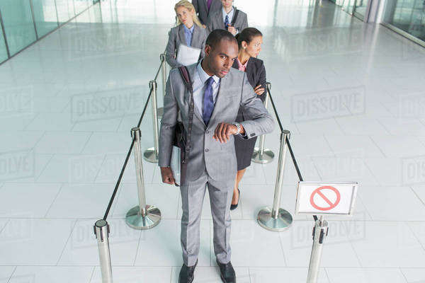 Businessman waiting in line - Stock Photo - Dissolve