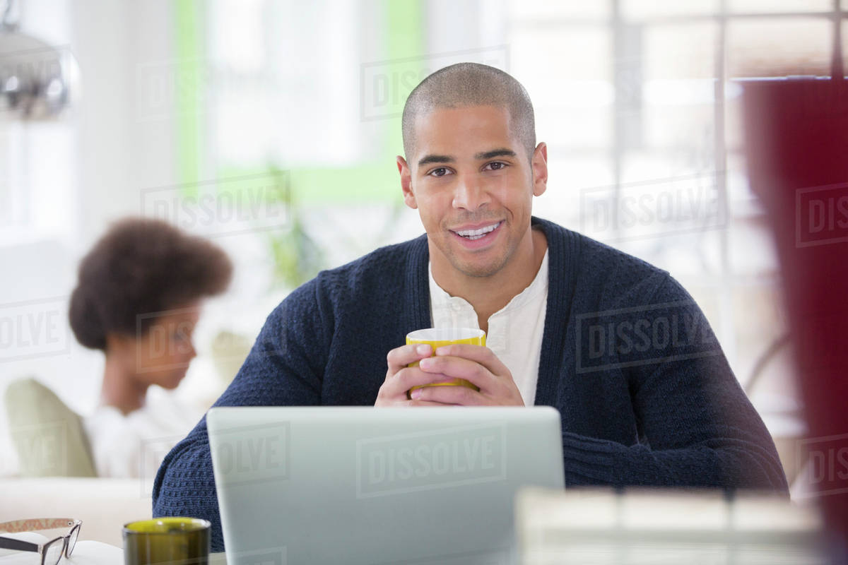Man using laptop at table - Stock Photo - Dissolve