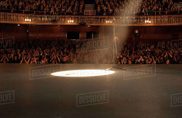 Spotlight shining on stage in theater - Stock Photo - Dissolve