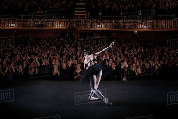 Ballerina bowing on stage in theater - Stock Photo - Dissolve