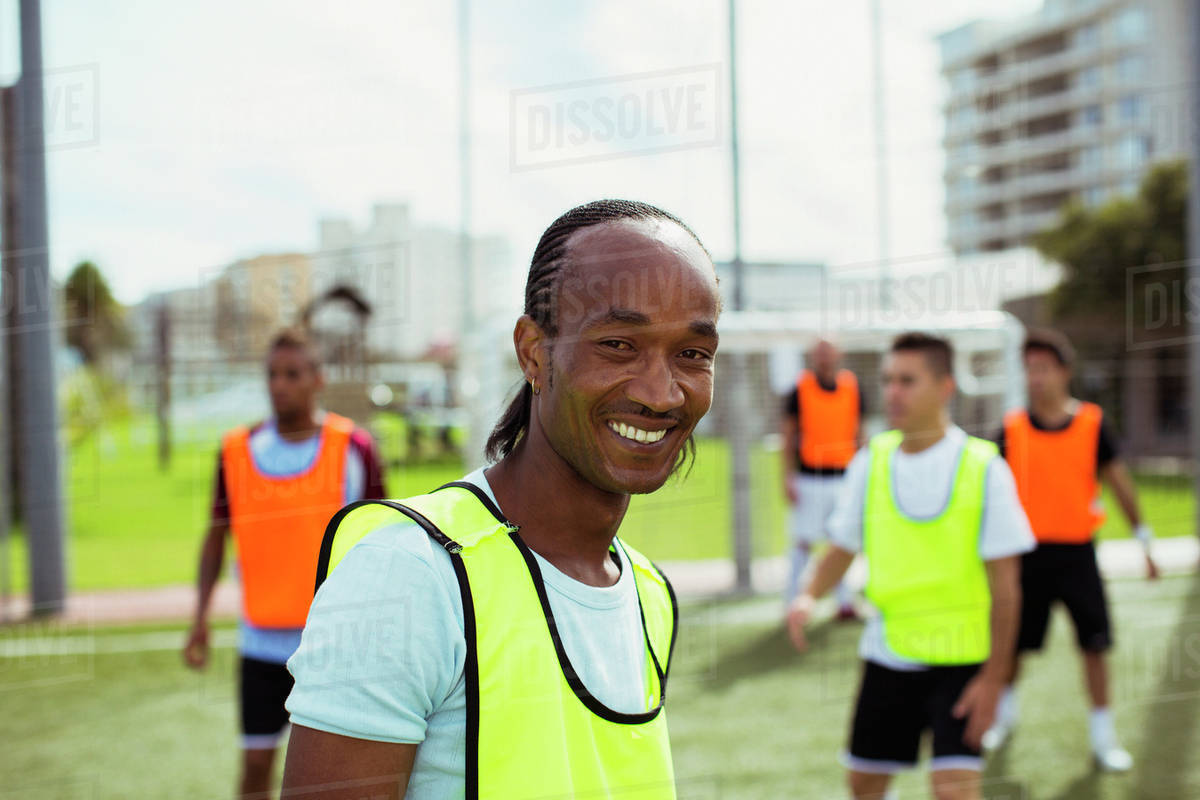 Soccer player smiling on field - Royalty-free Stock Photo | Dissolve