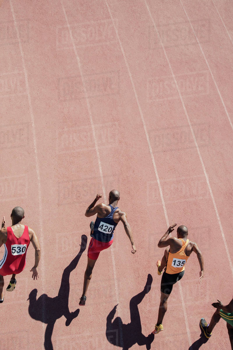 Runners racing on track - Stock Photo - Dissolve