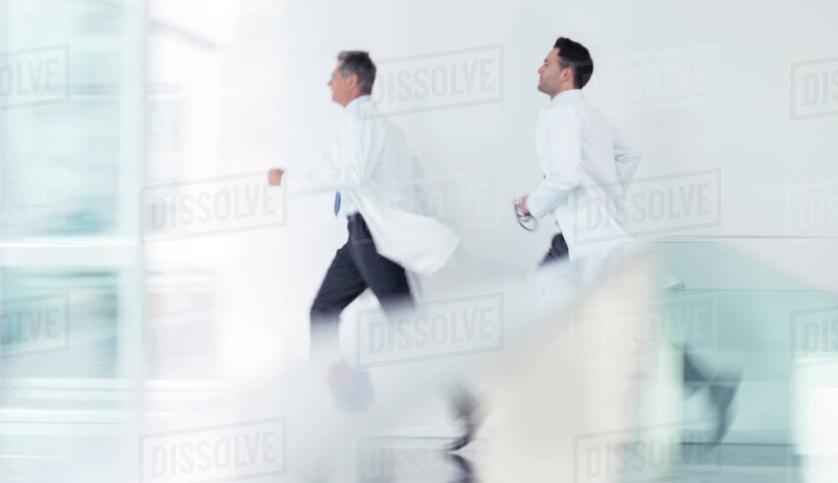 Doctors running in hospital corridor - Royalty-free Stock Photo | Dissolve