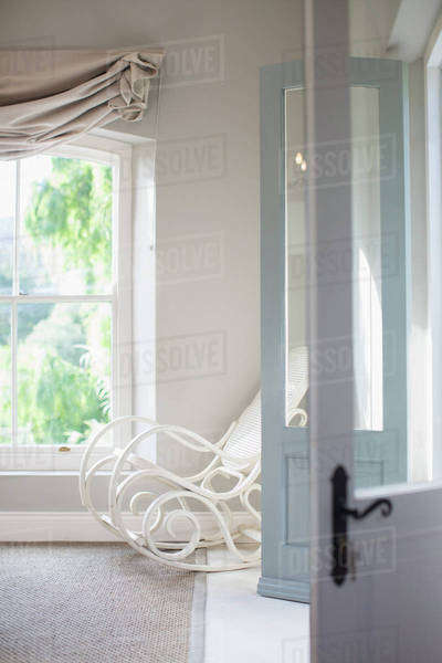 Antique rocking chair in bedroom corner - Stock Photo - Dissolve
