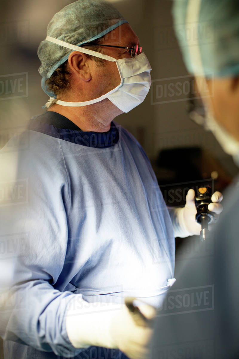 Doctor performing laparoscopic surgery in operating theater - Royalty ...