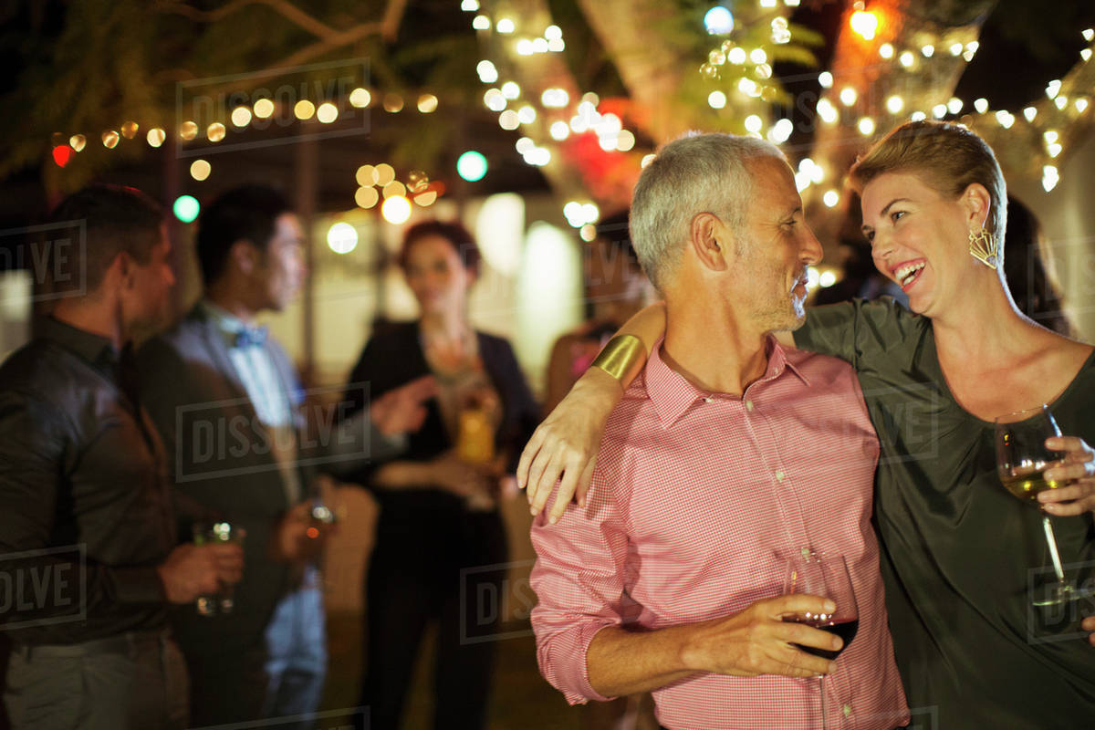Couple hugging at party - Royalty-free Stock Photo | Dissolve