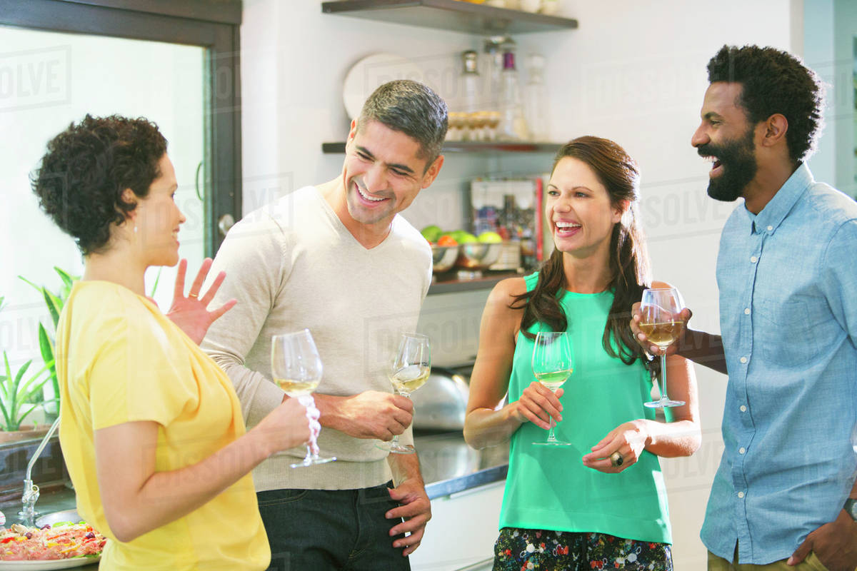 Couples talking at party - Royalty-free Stock Photo | Dissolve