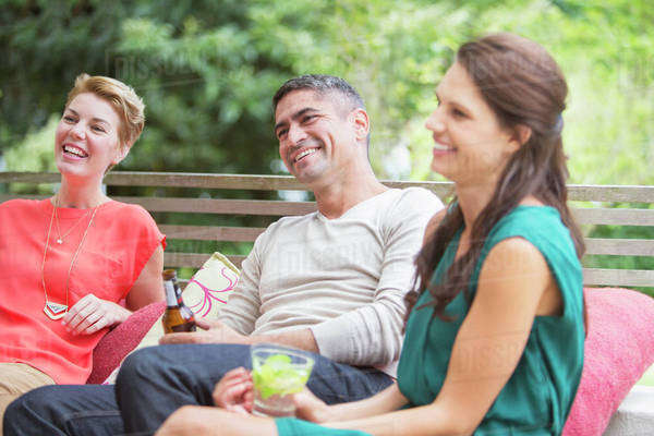 Friends relaxing together outdoors - Royalty-free Stock Photo | Dissolve