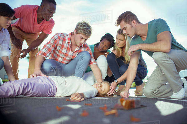 People rushing to injured girl on street - Stock Photo - Dissolve