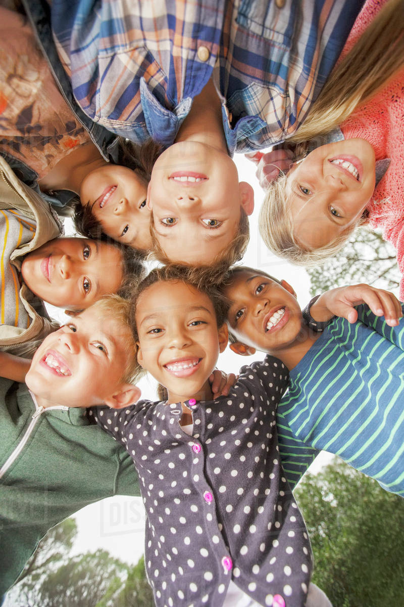 Children huddled together outdoors - Royalty-free Stock Photo | Dissolve