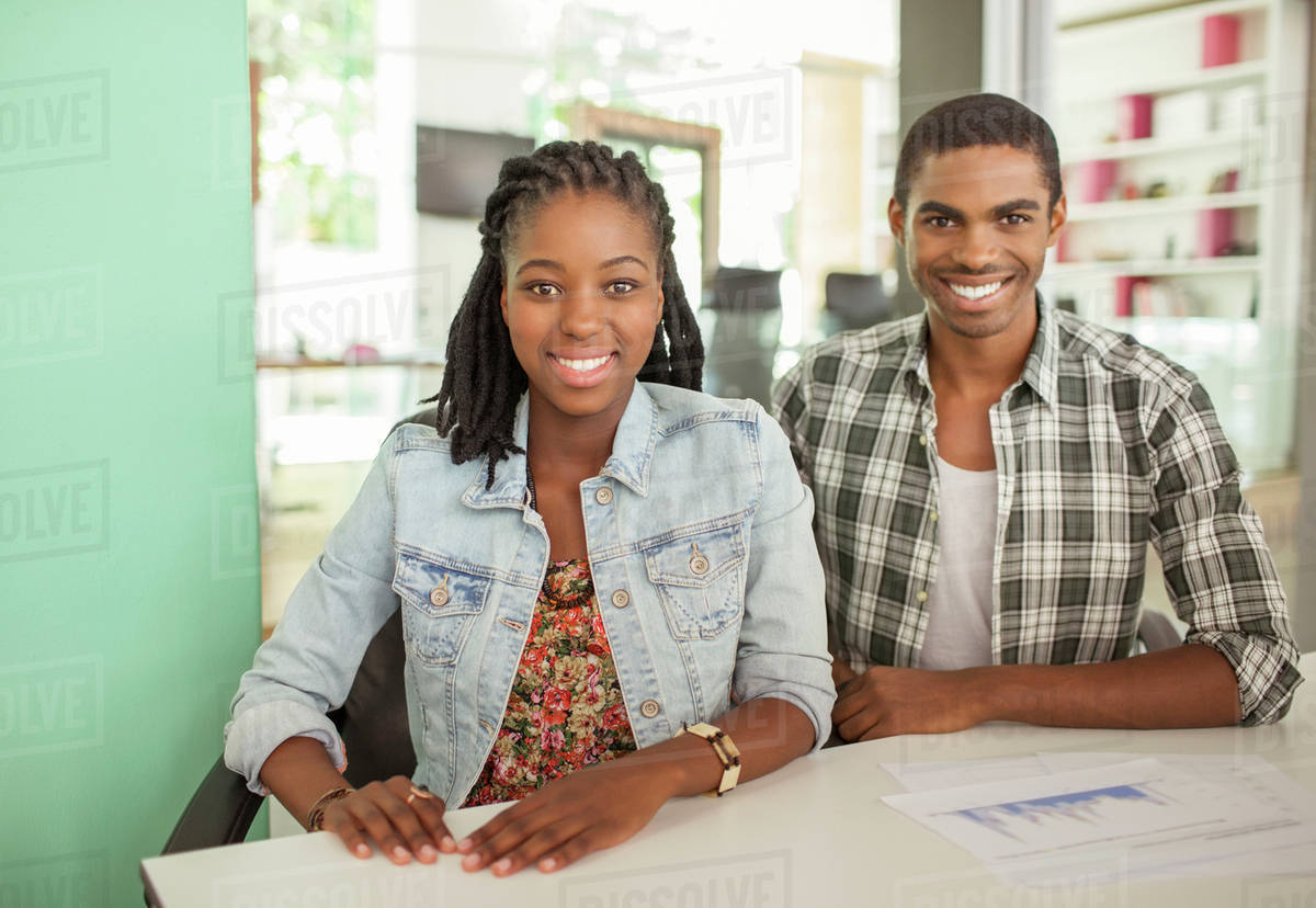 People smiling together in office - Stock Photo - Dissolve