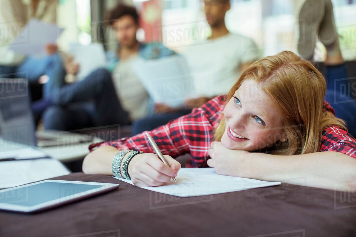 Woman writing in office - Royalty-free Stock Photo | Dissolve