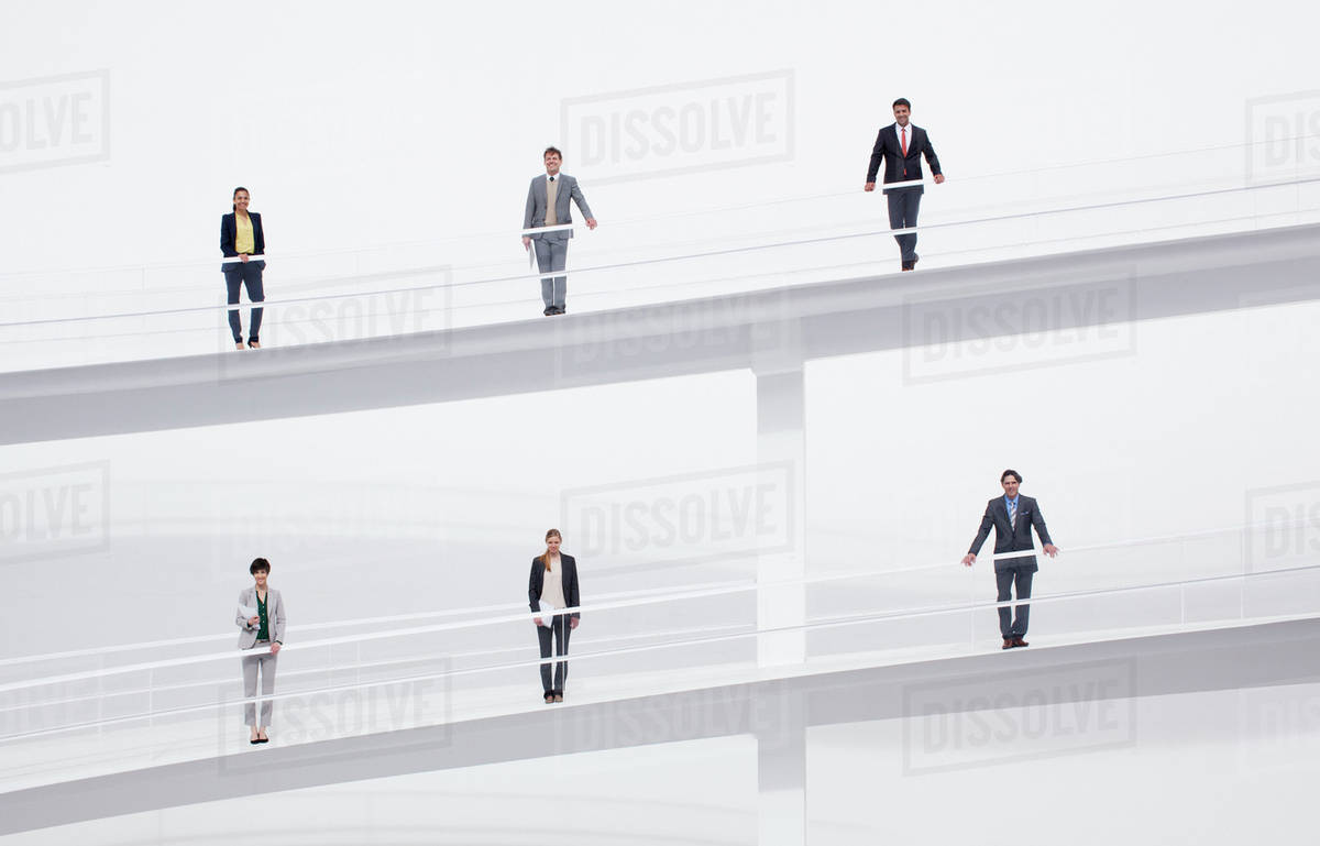 Portrait of business people at railings of elevated walkways - Royalty ...