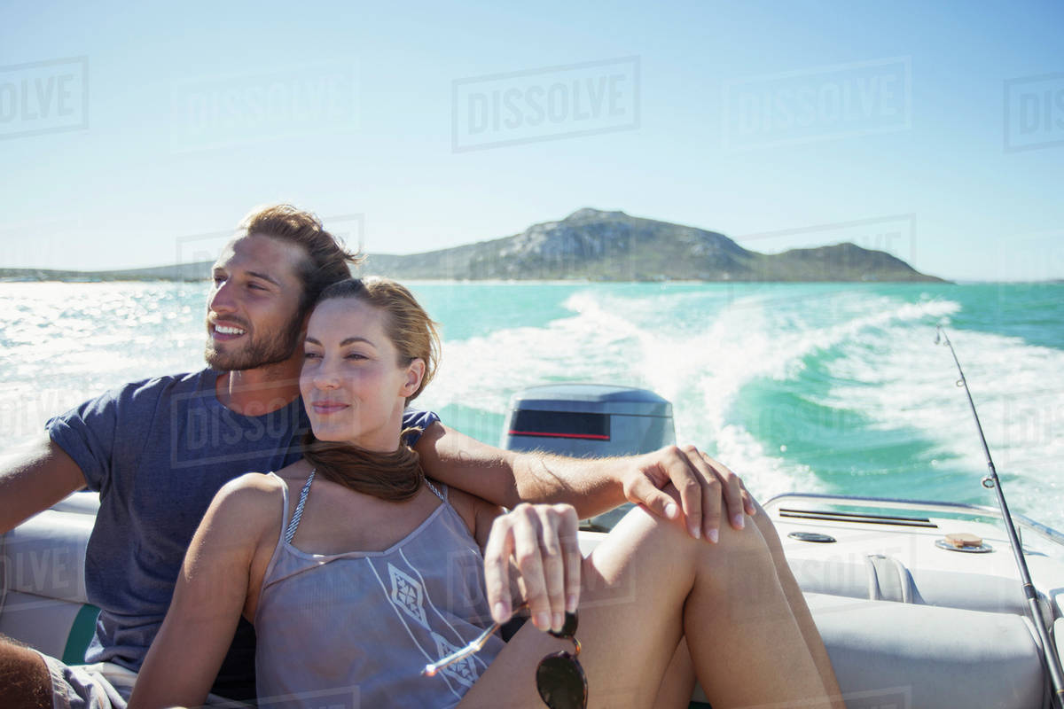 Couple sitting on boat together - Stock Photo - Dissolve