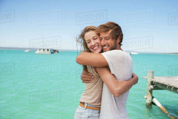 Couple hugging near water - Stock Photo - Dissolve