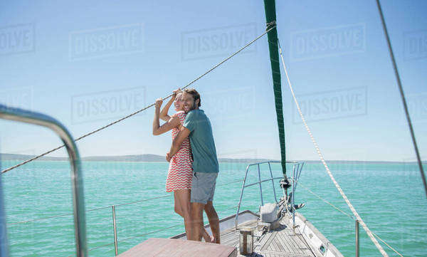 Couple standing on boat together - Stock Photo - Dissolve