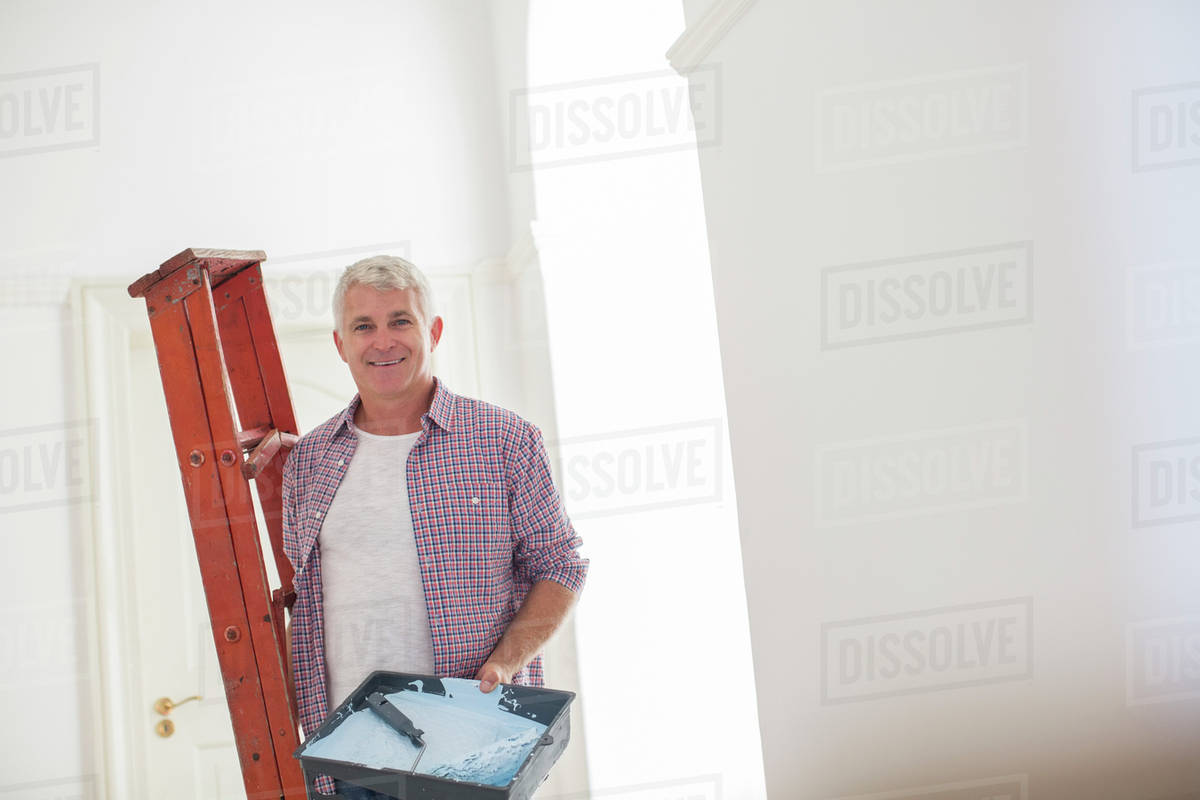 Older man carrying ladder and paint tray - Royalty-free Stock Photo ...