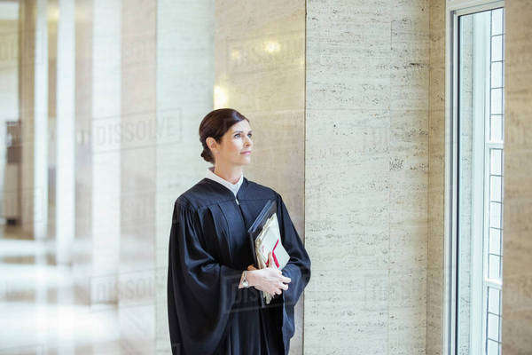 Judge looking out window in courthouse - Stock Photo - Dissolve